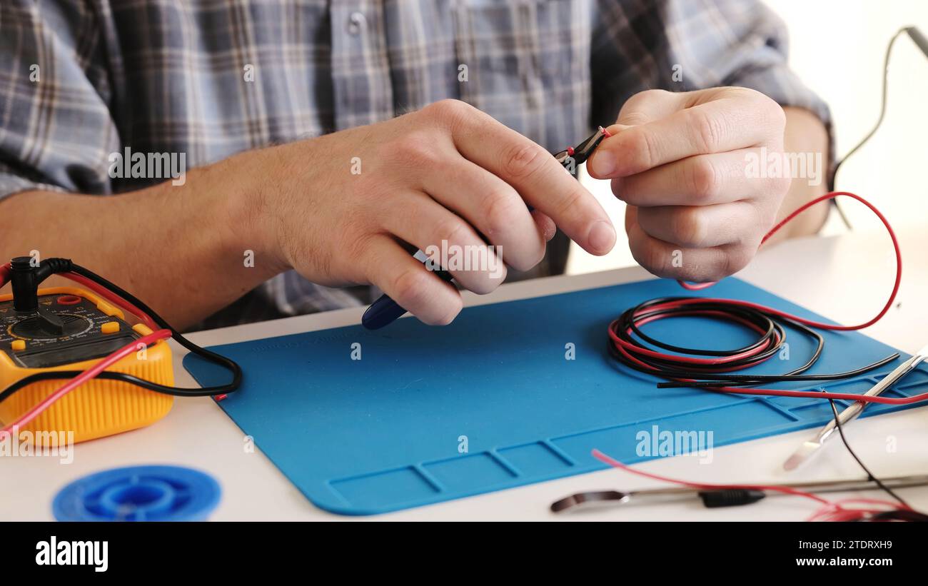 Master Preparing Electric Wires For Soldering In Service Technic Center ...