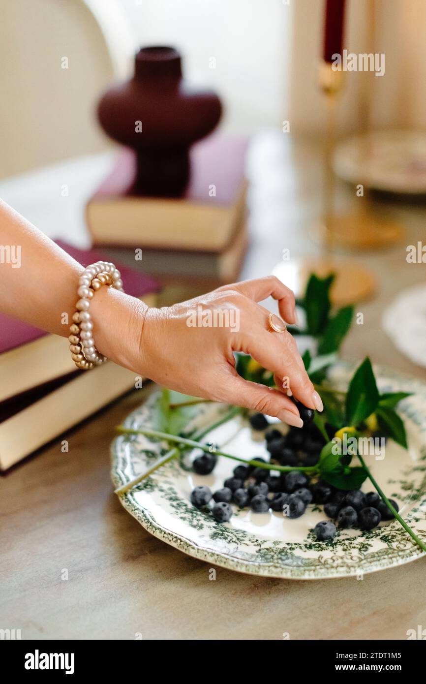 Female hand takes blueberry hi-res stock photography and images - Alamy