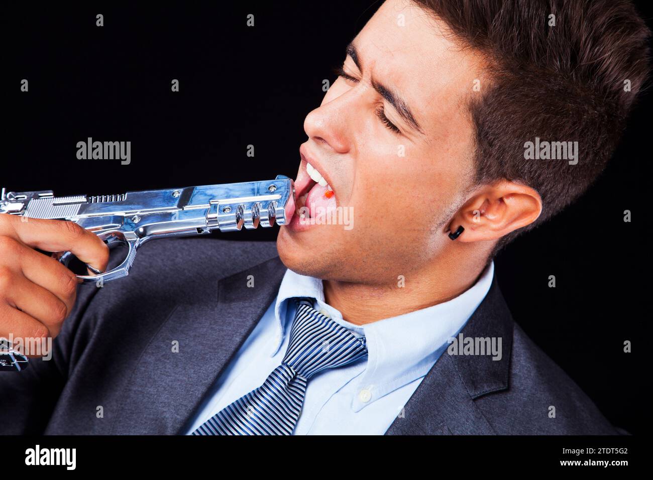 Stressed young businessman with a gun pointing to his head (isolated on ...
