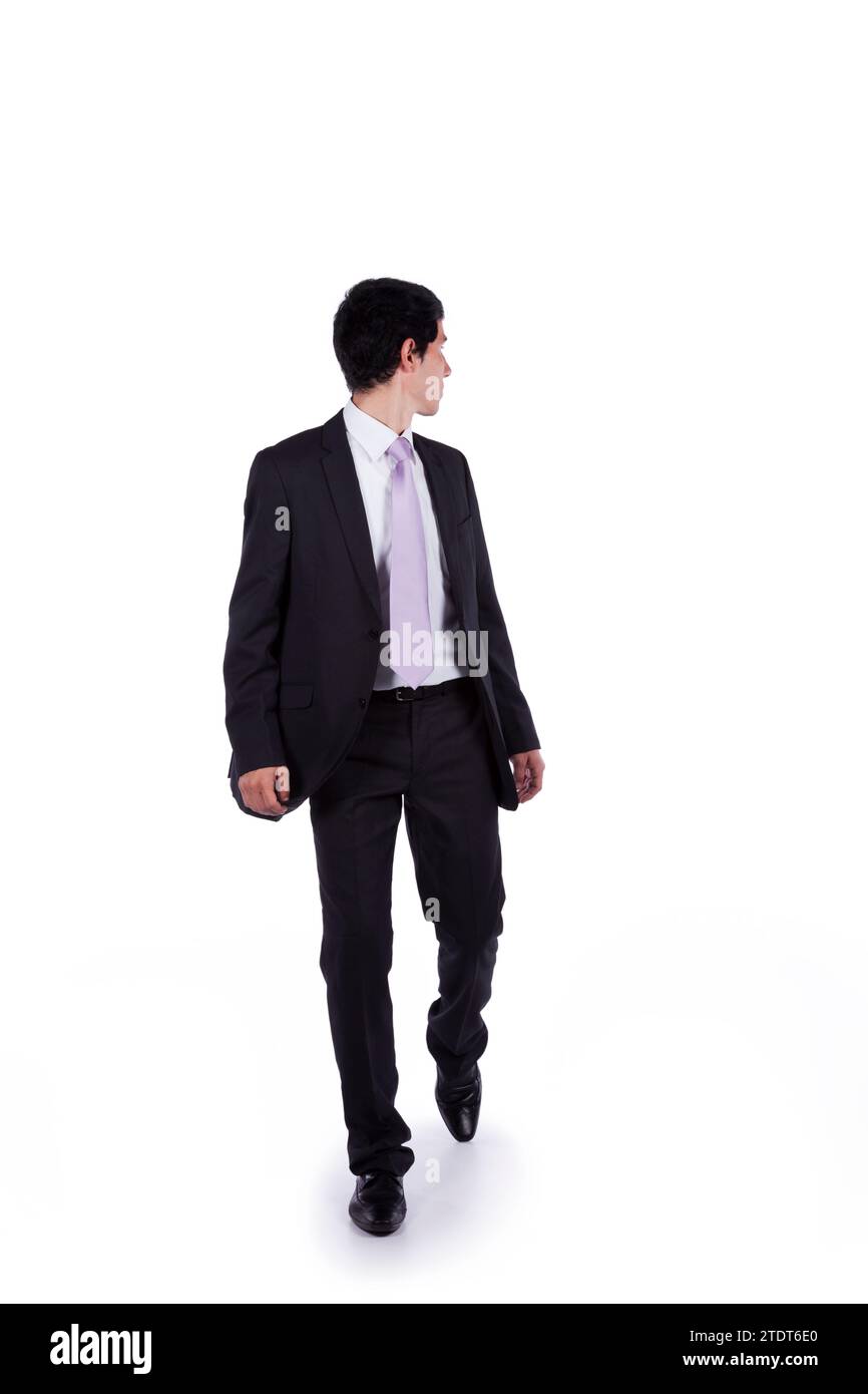 Businessman walking and looking back isolated on white (some motion ...