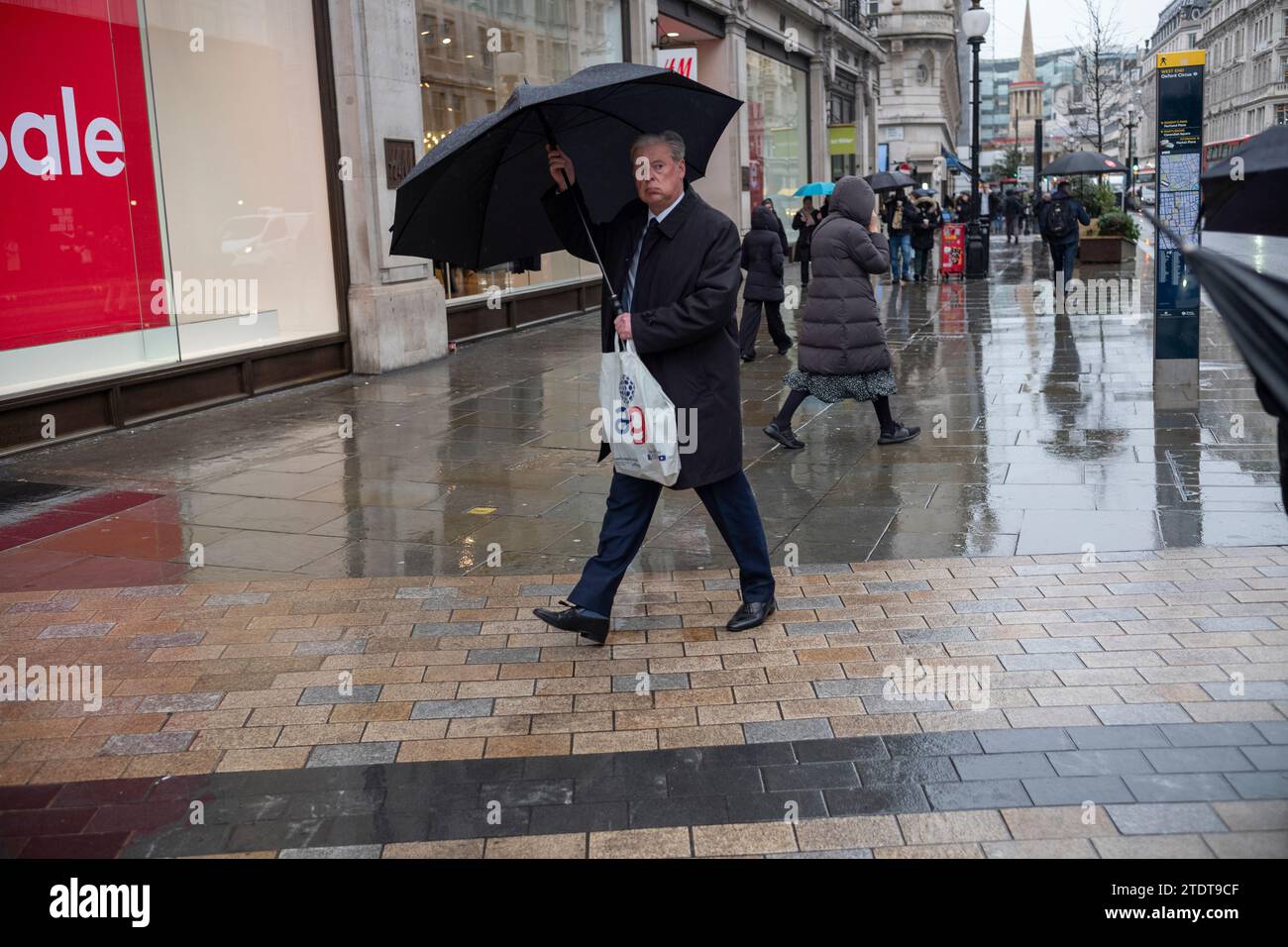 Christmas shoppers along Old Bond Street on a wet winters day, London ...