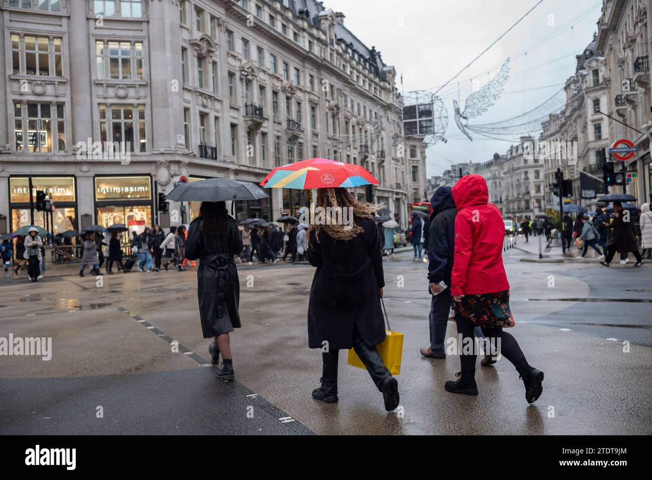 Christmas shoppers in Oxford Circus on a wet winters day, London ...