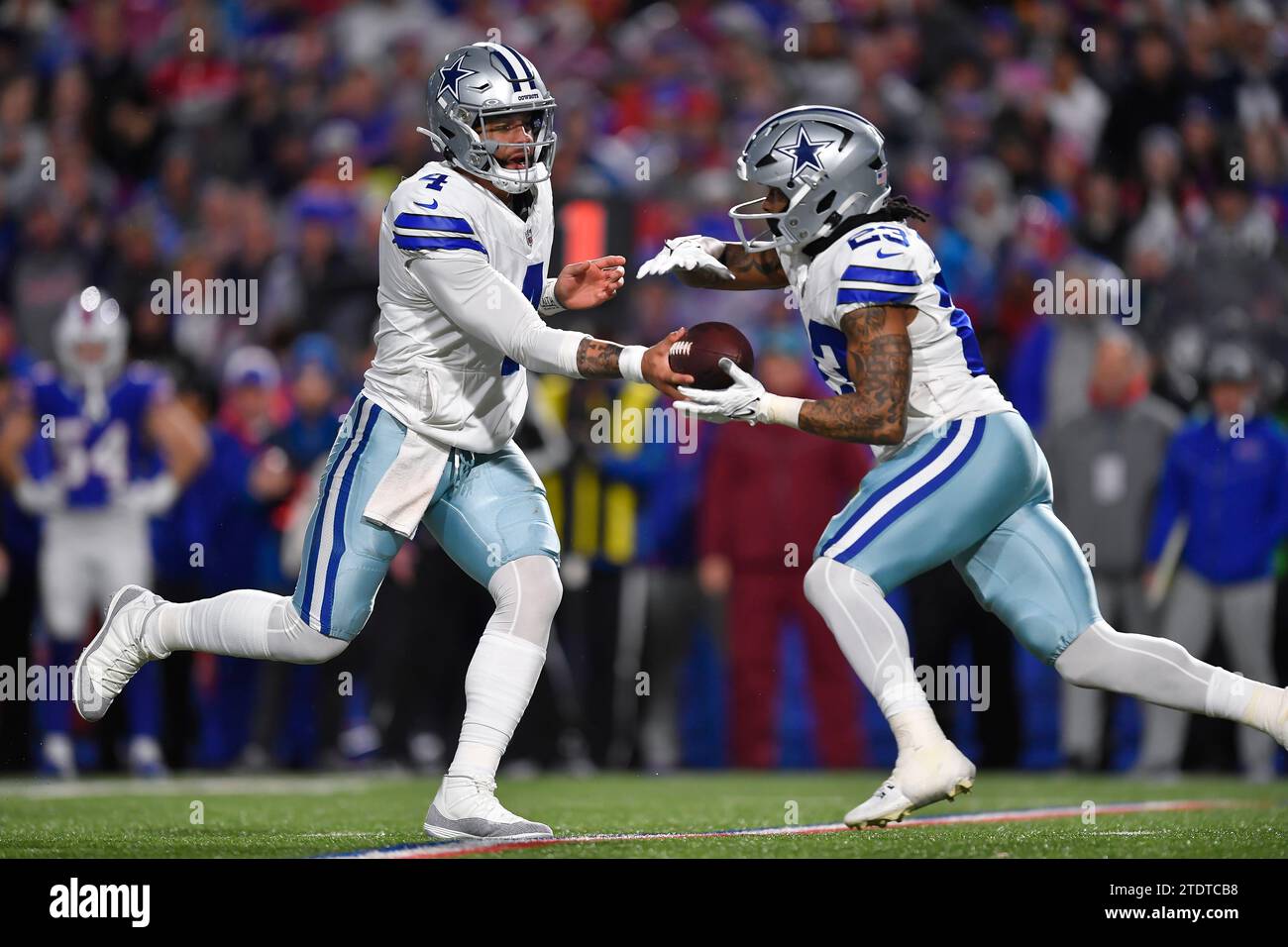 Dallas Cowboys quarterback Dak Prescott, left, hands the ball to ...