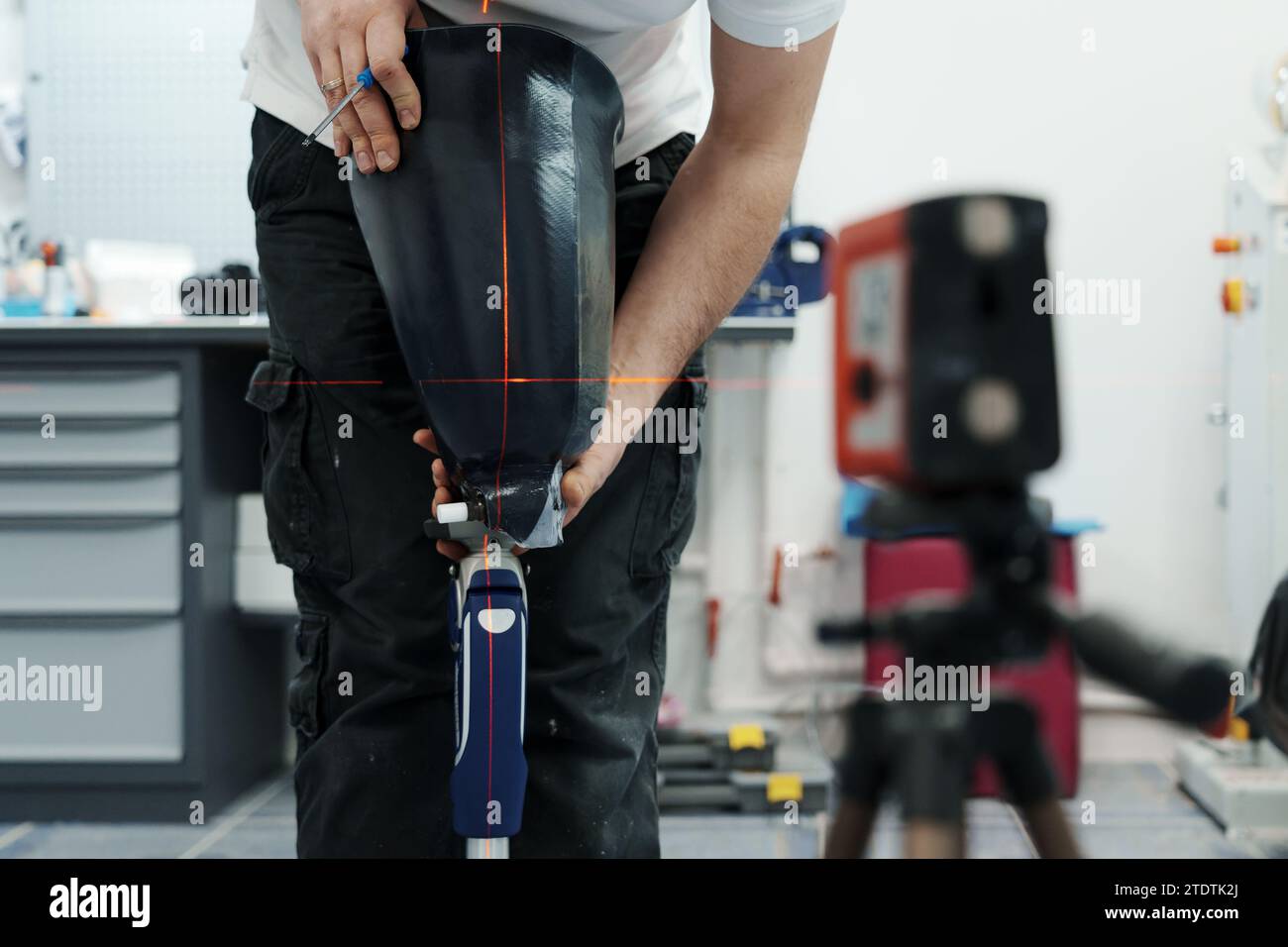Crop unrecognizable craftsman adjusting and bending modern prosthetic ...