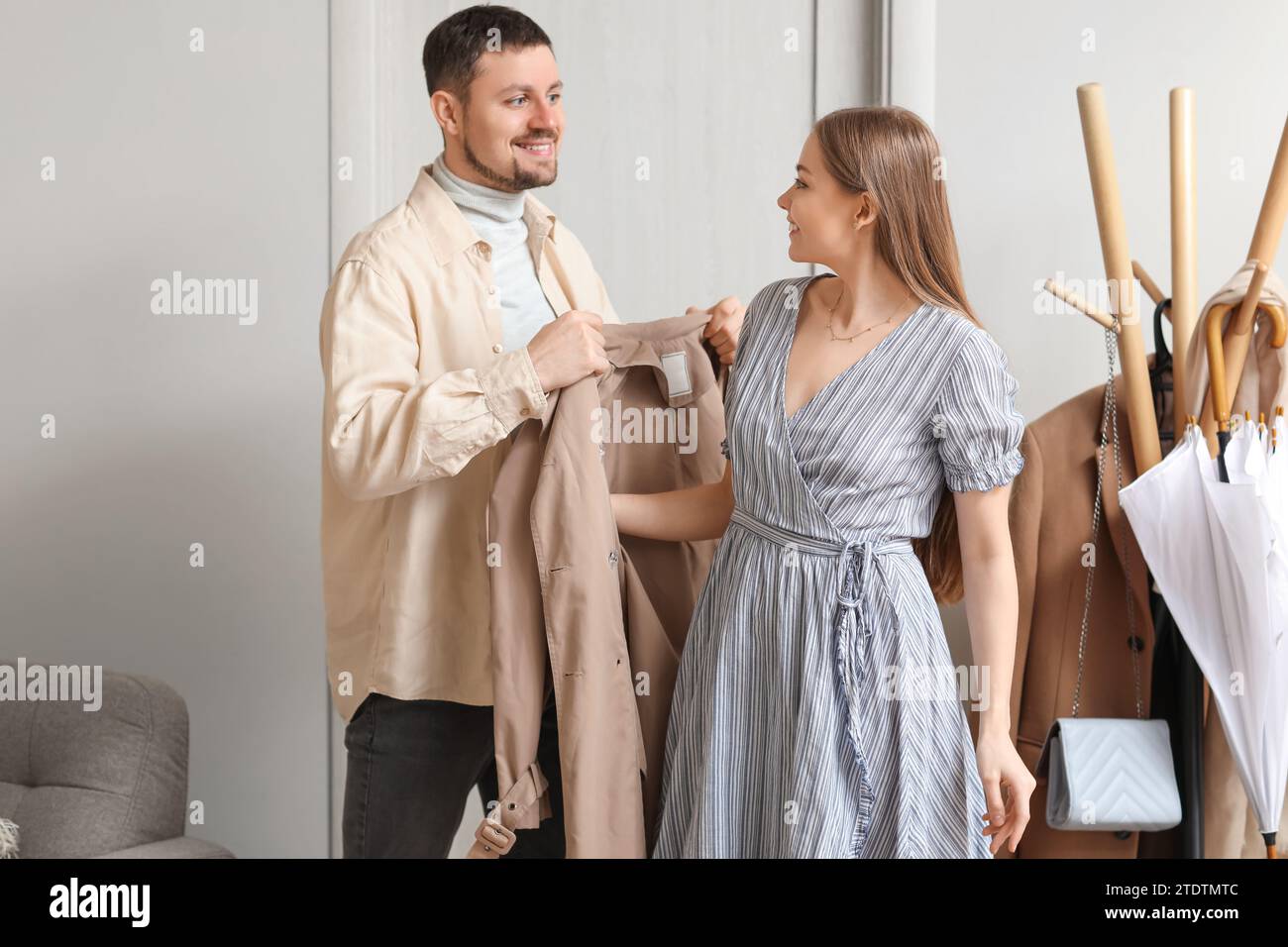 Putting coat on hi-res stock photography and images - Alamy