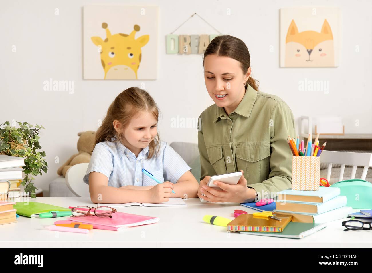Cute little girl doing Math with her mother at home Stock Photo - Alamy