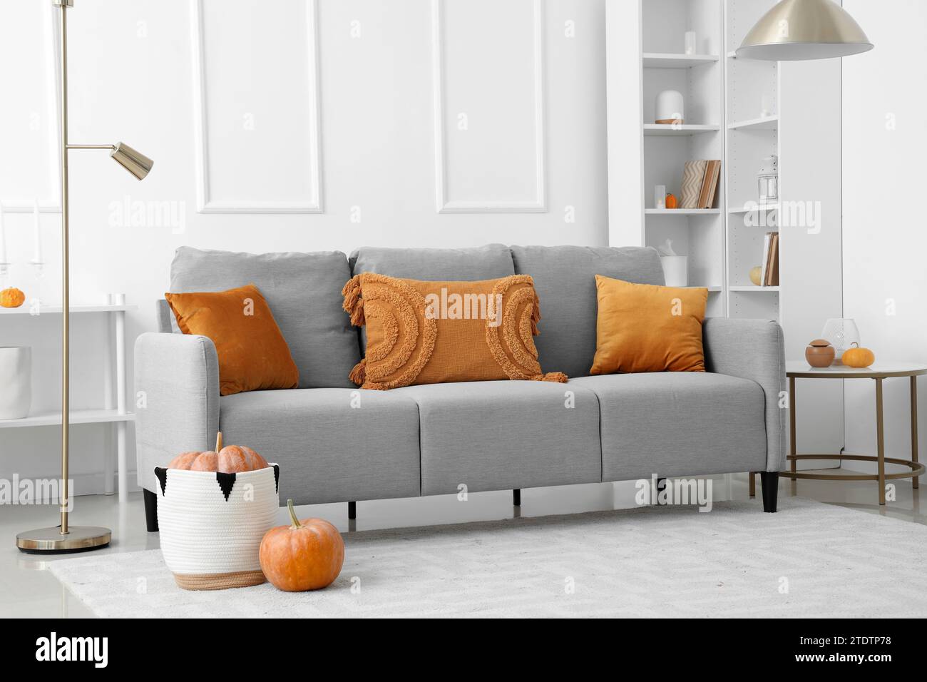 Autumn interior of living room with cozy grey sofa, cushions and ...