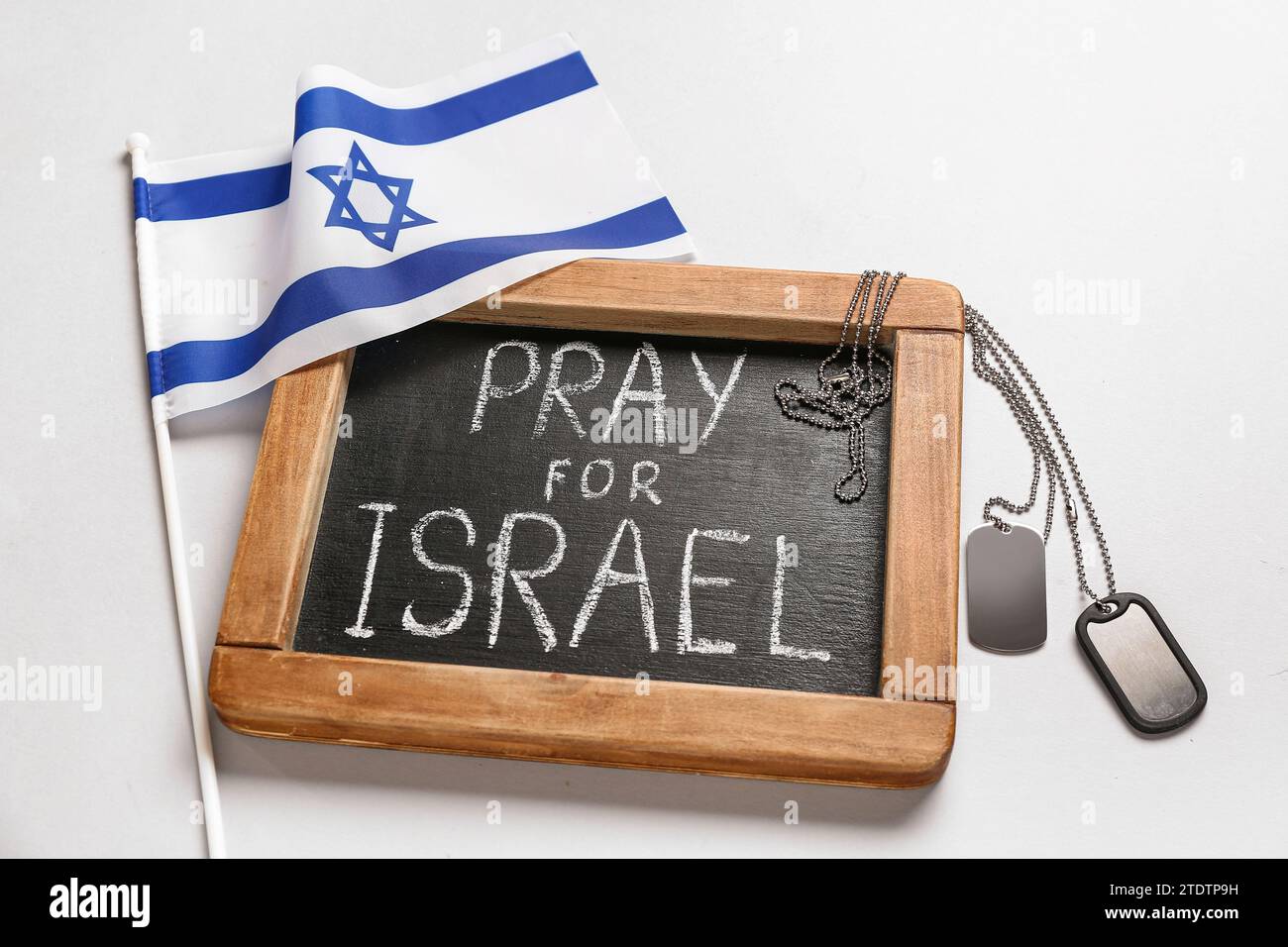Chalkboard with text PRAY FOR ISRAEL, flag and dog tags on white ...
