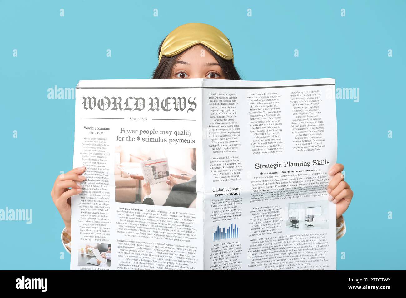 Beautiful young Asian woman in pajamas with sleeping mask and newspaper ...