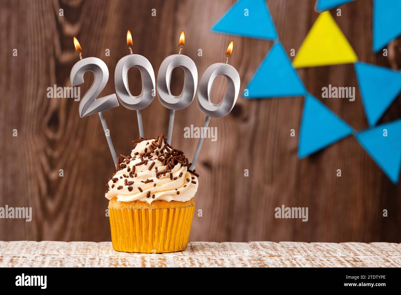 Candle number 2000 - Wooden background with pennants Stock Photo - Alamy