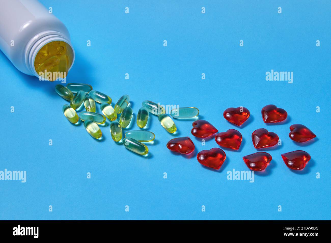 Omega 3 polyunsaturated fatty acids and red hearts pour out from a ...