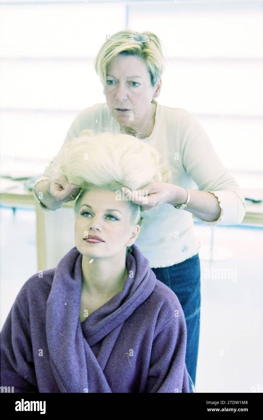 A woman gets a wig put on, Whizgle News from the Past, Tailored for the ...