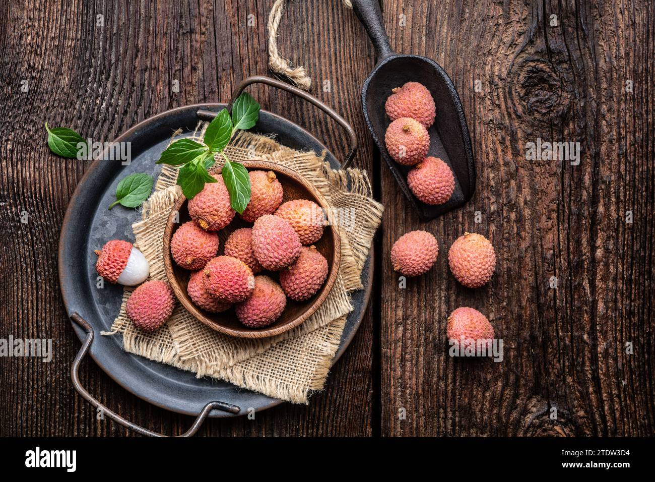 Bowl of ripe tropical lichee fruit (Litchi chinensis) on wooden ...
