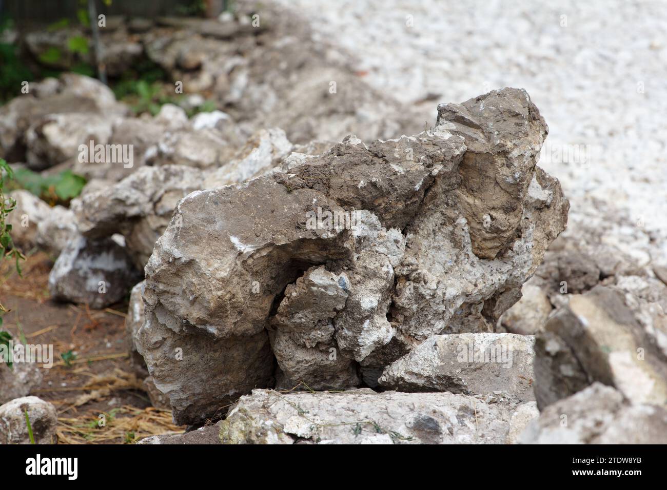 Construction, laying road on a new one. On side of the road lie blocks ...