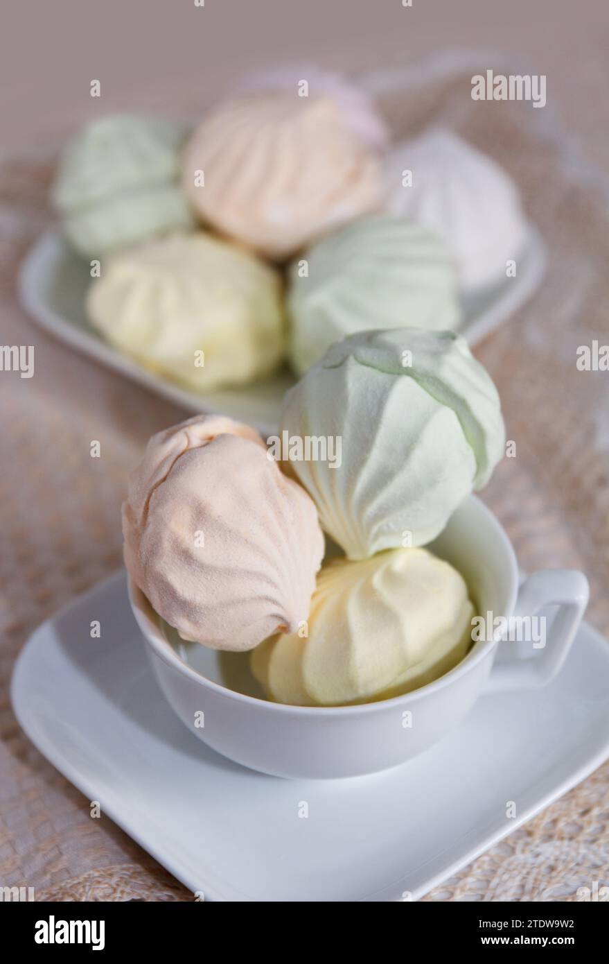 Delicious fresh multicolored air marshmallow lies on a serviced table ...