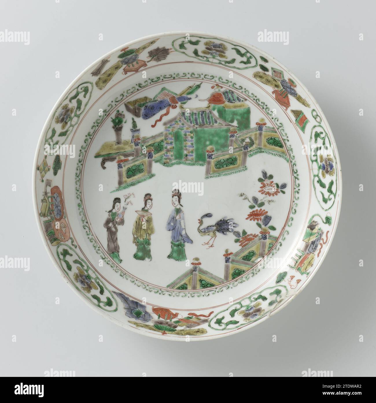 Saucer-dish with three women and a peacock in a fenced garden in front ...