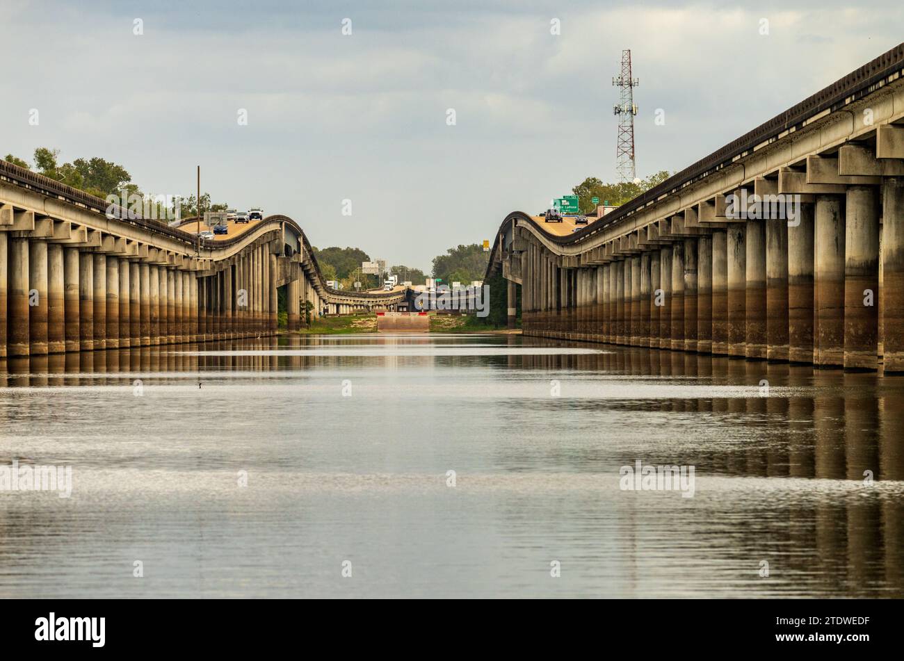 Receding pillars of the I-10 interstate bridges over the bayou of ...