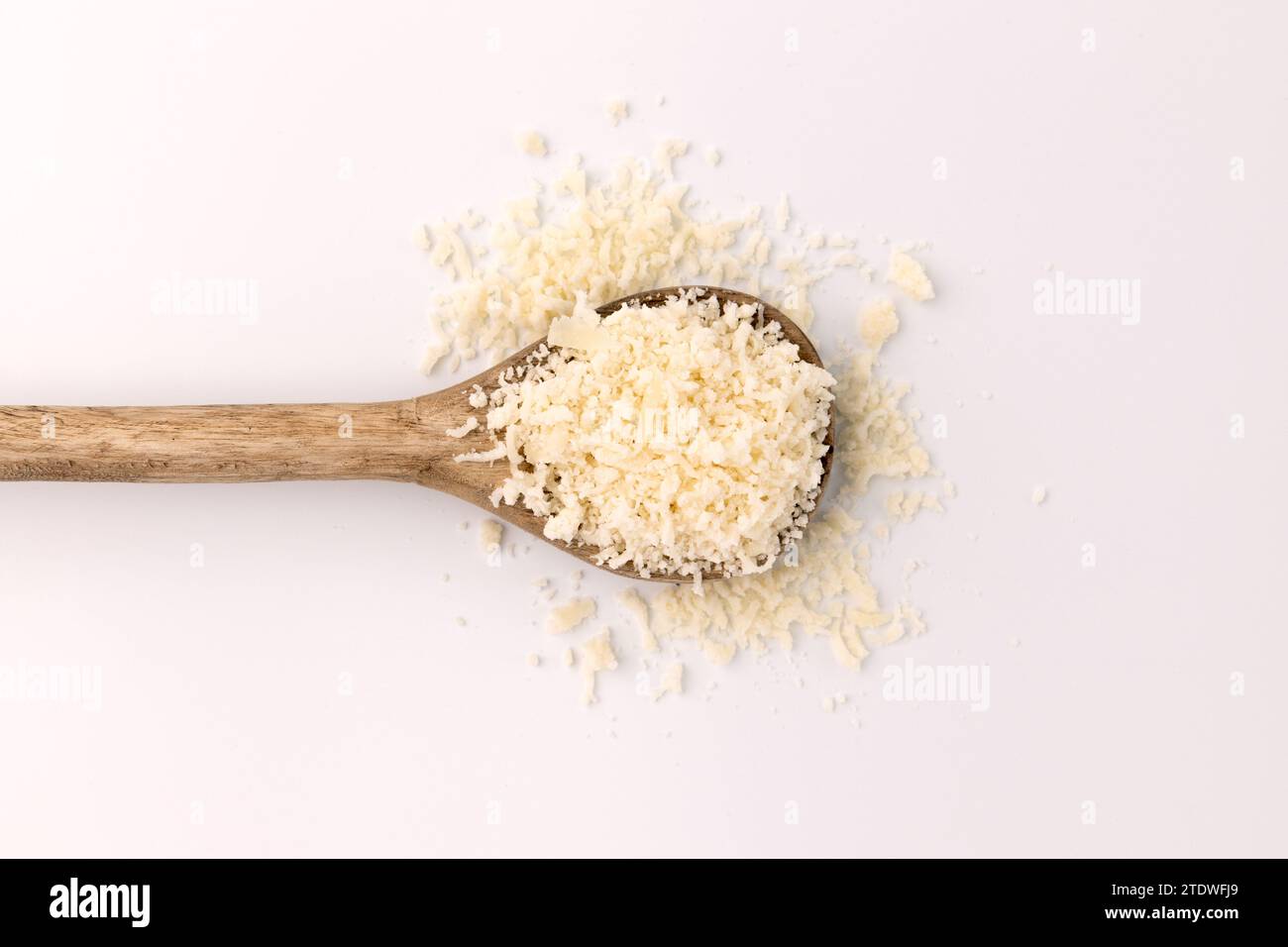 grated cheese parmesan in wooden spoon isolated on white background ...