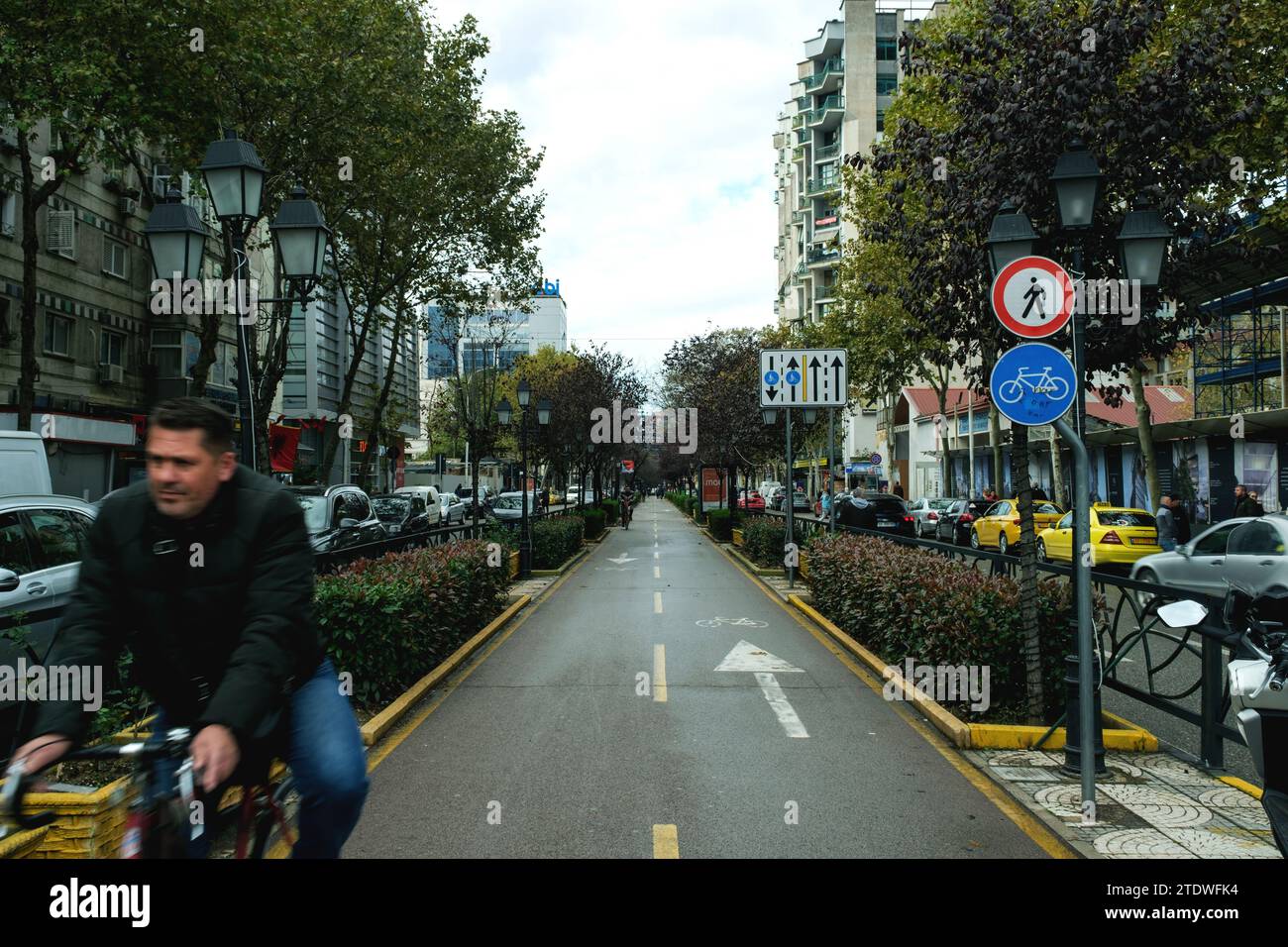 Tirana, Albania - November 29, 2023: A photo capturing a man riding a bicycle on a designated ...