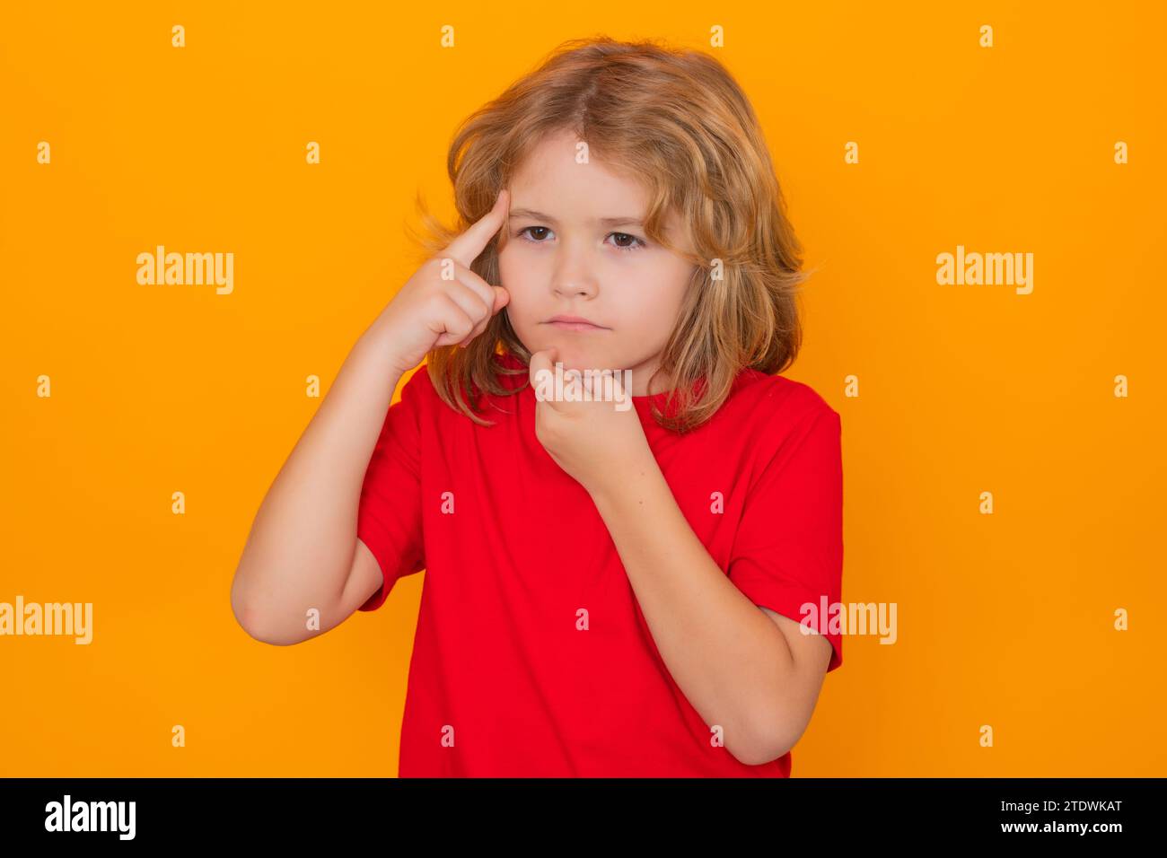 Kid have idea on yellow isolated background. Child pointing up ...