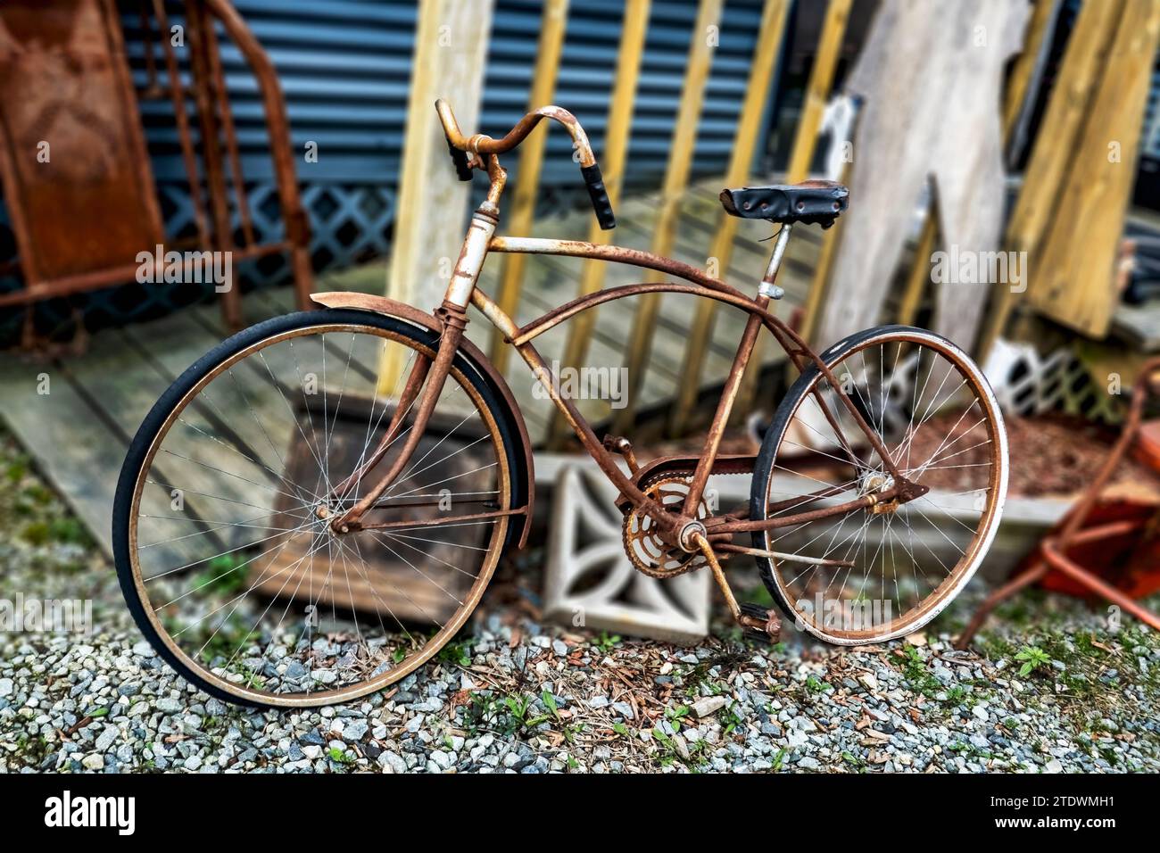 Rusting mid 20th Century bicycle at a small roadside store dealing in ...