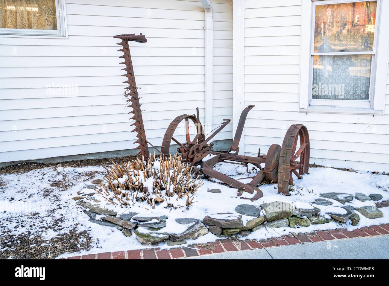 A piece of antique farm equipment sits in the snow outside the Daniel ...