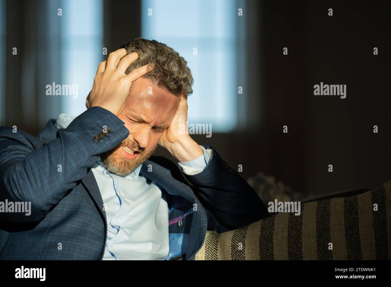 Man with sinus headache, tension or cluster headache, close up portrait ...