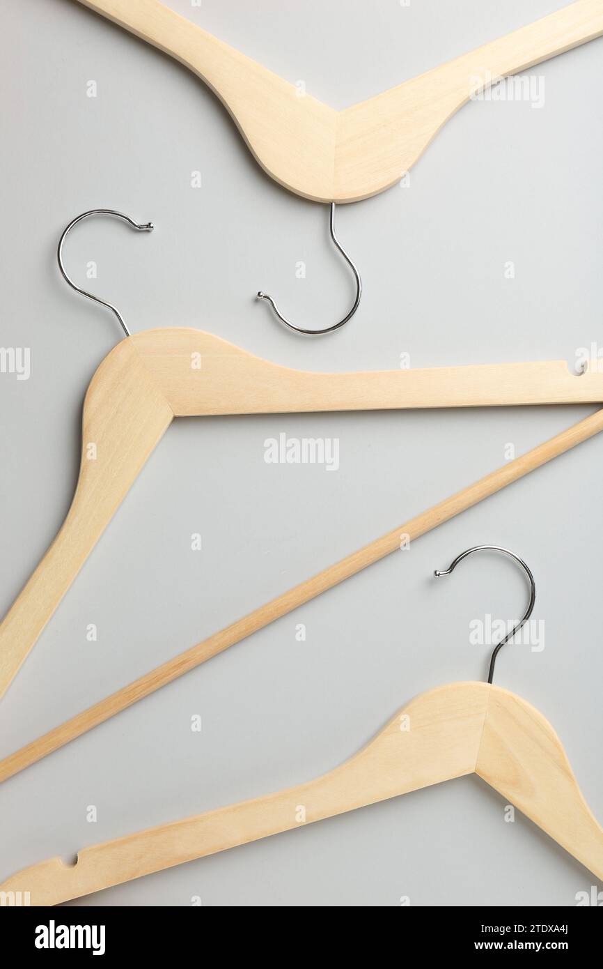 Wooden hangers on light gray background, flat lay Stock Photo - Alamy