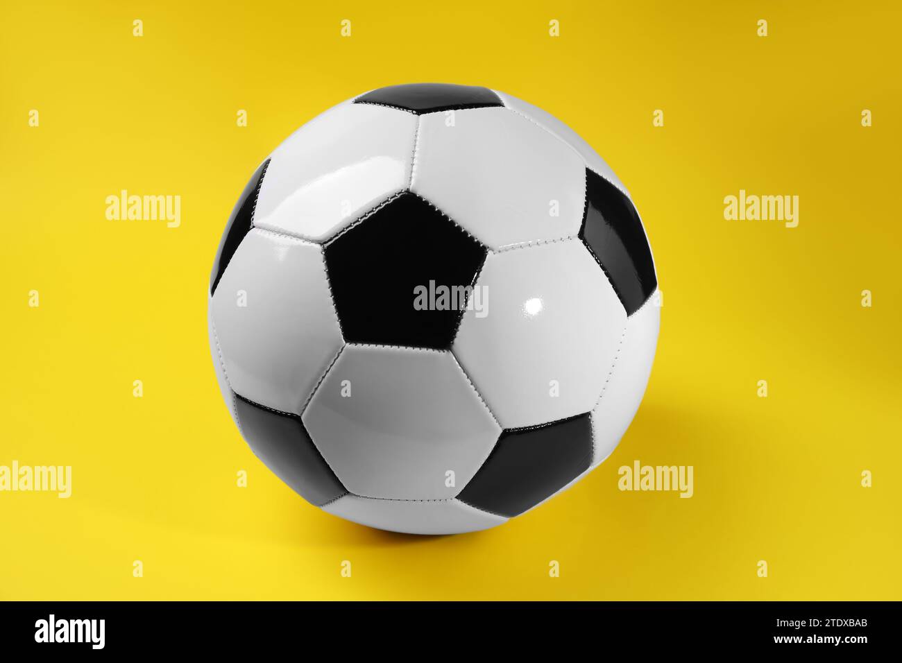 Soccer ball on yellow hi-res stock photography and images - Alamy