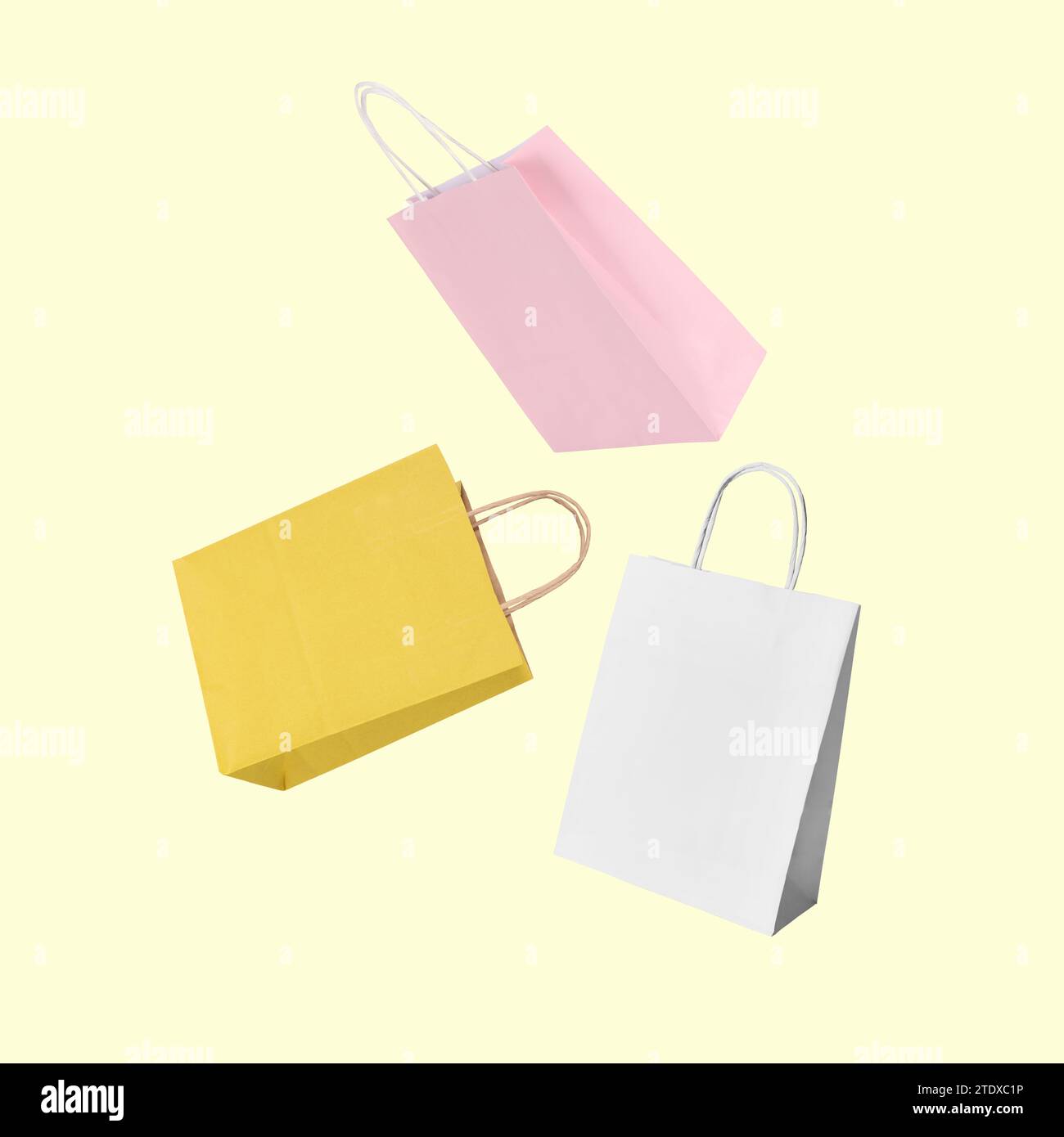 Colorful shopping bags falling on beige background Stock Photo - Alamy