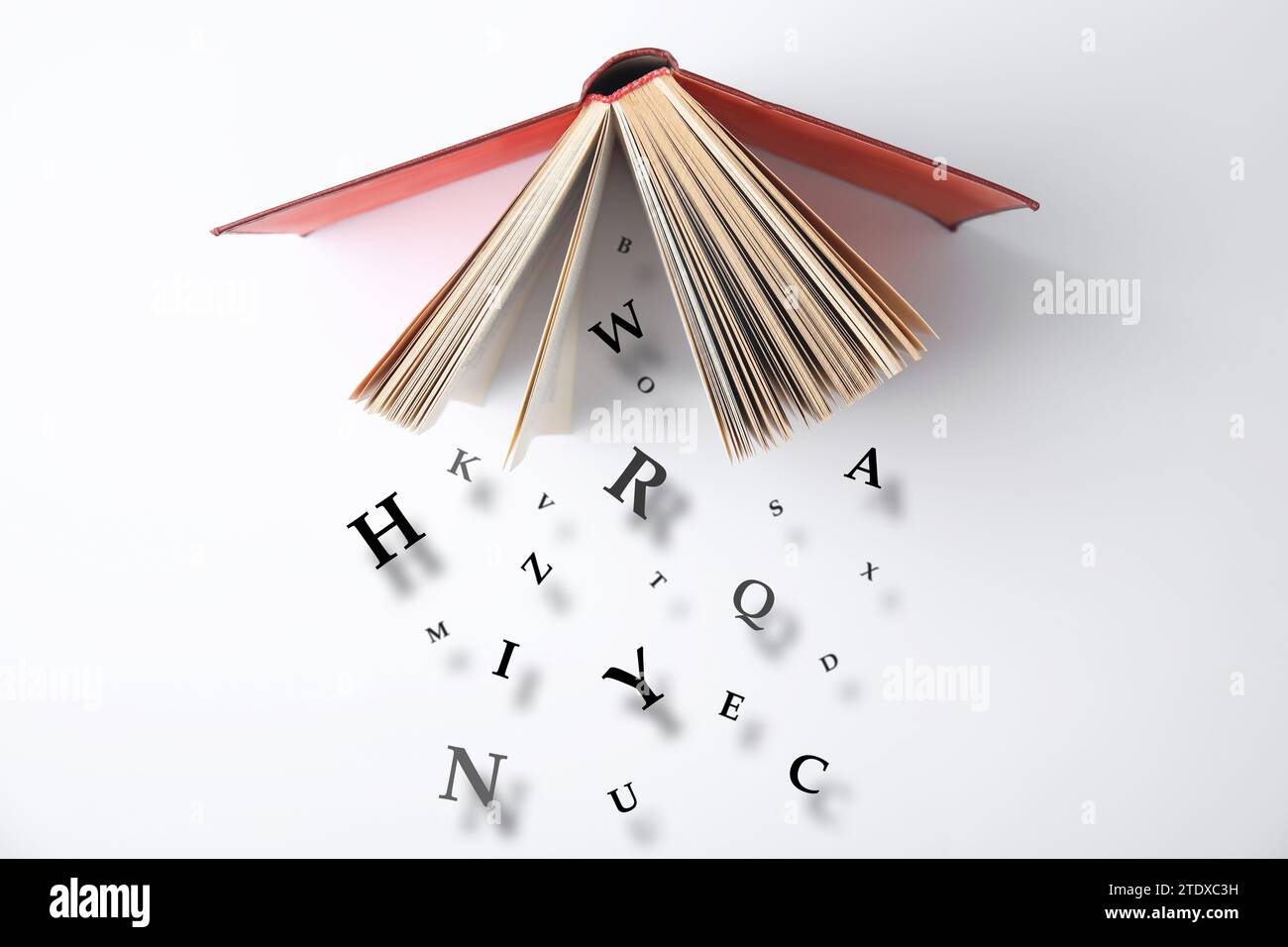 Open book with letters falling out of it on white background Stock ...