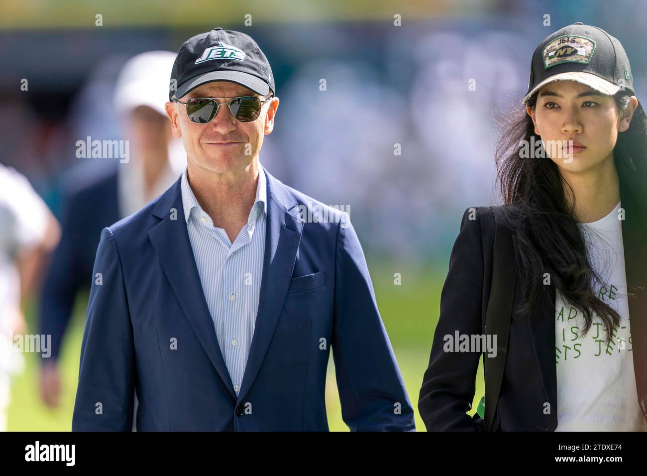 New York Jets vice chairman Christopher Johnson smiles as he walks with his wife Doris Wong on ...