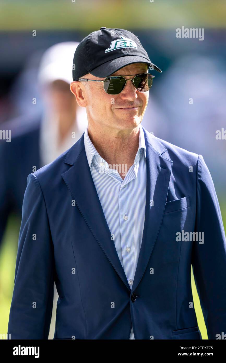 New York Jets vice chairman Christopher Johnson smiles as he walks on ...