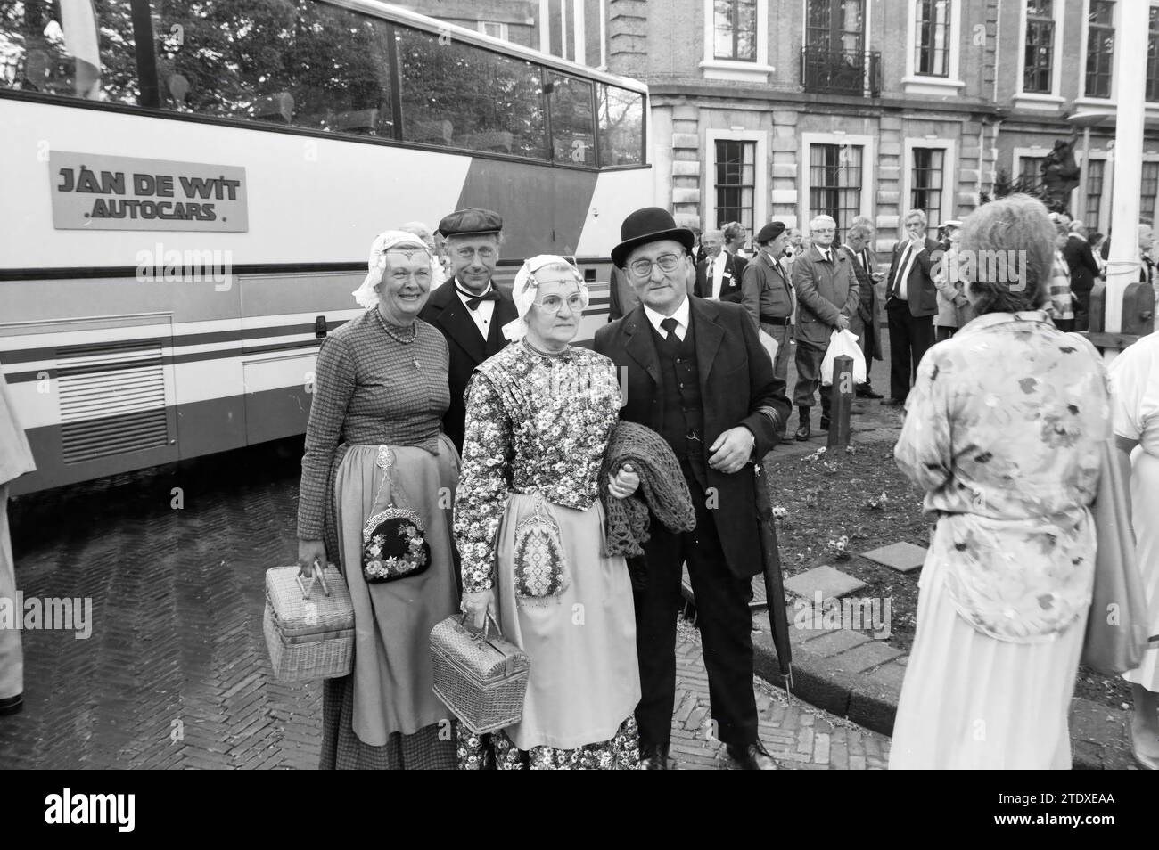 Saying goodbye to a group of people in traditional costumes at the ...