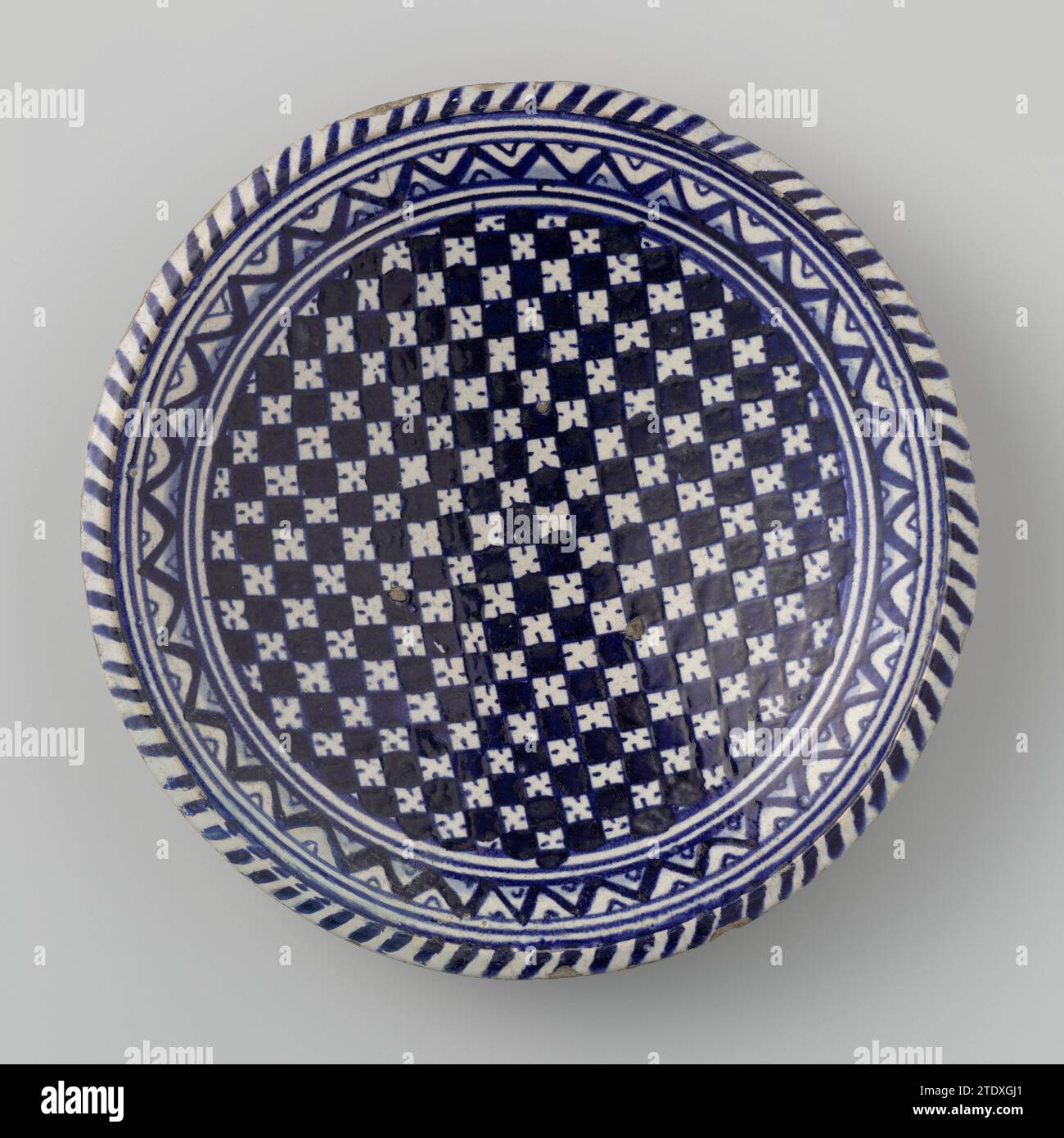 Dish, painted with a blue and white diamond pattern surrounded by concentric circles within ...