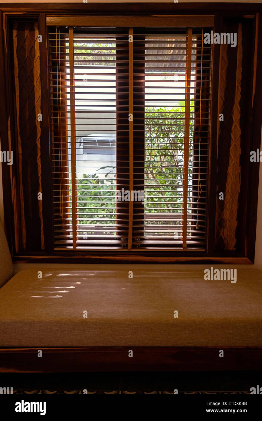 Light coming through wooden window blinds into living room Stock Photo ...
