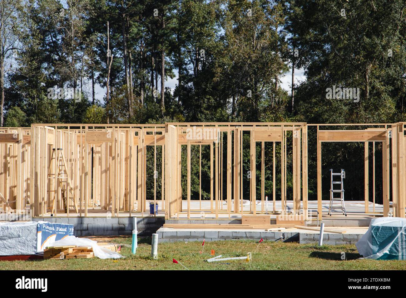 New construction house frame framing being built with a foundation and ...