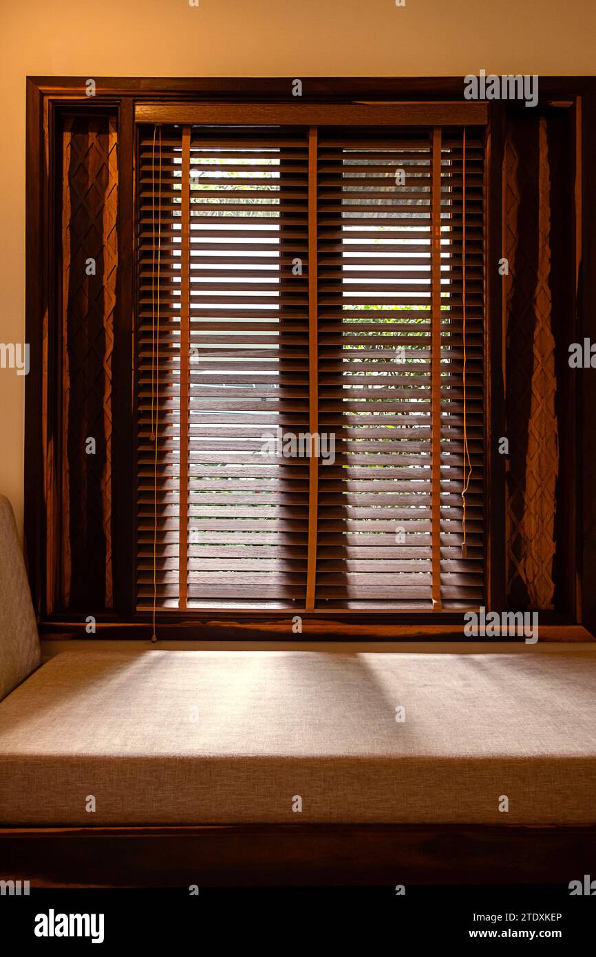 Light coming through wooden window blinds into living room Stock Photo ...