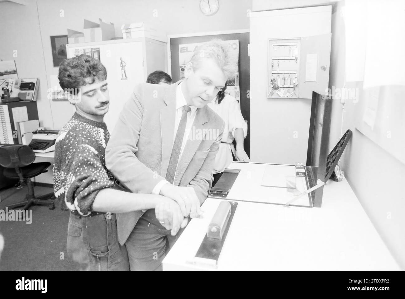 Fred Visser takes a fingerprint from a man. Hoofddorp police, Hoofddorp ...