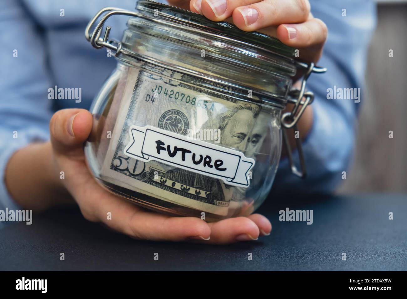 Female hands Saving Money In Glass Jar filled with Dollars banknotes ...