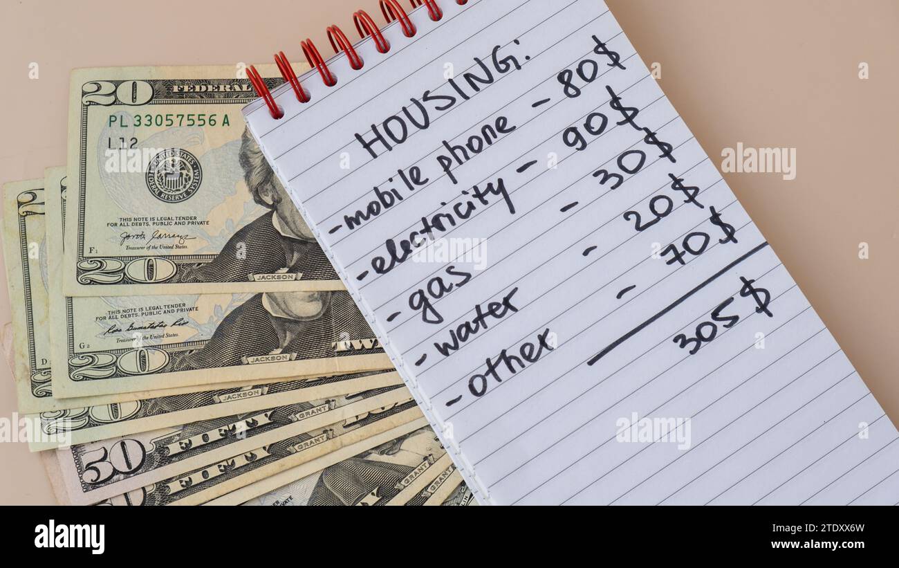 Dollar cash money with notebook handwritten housing expenses. Counting ...