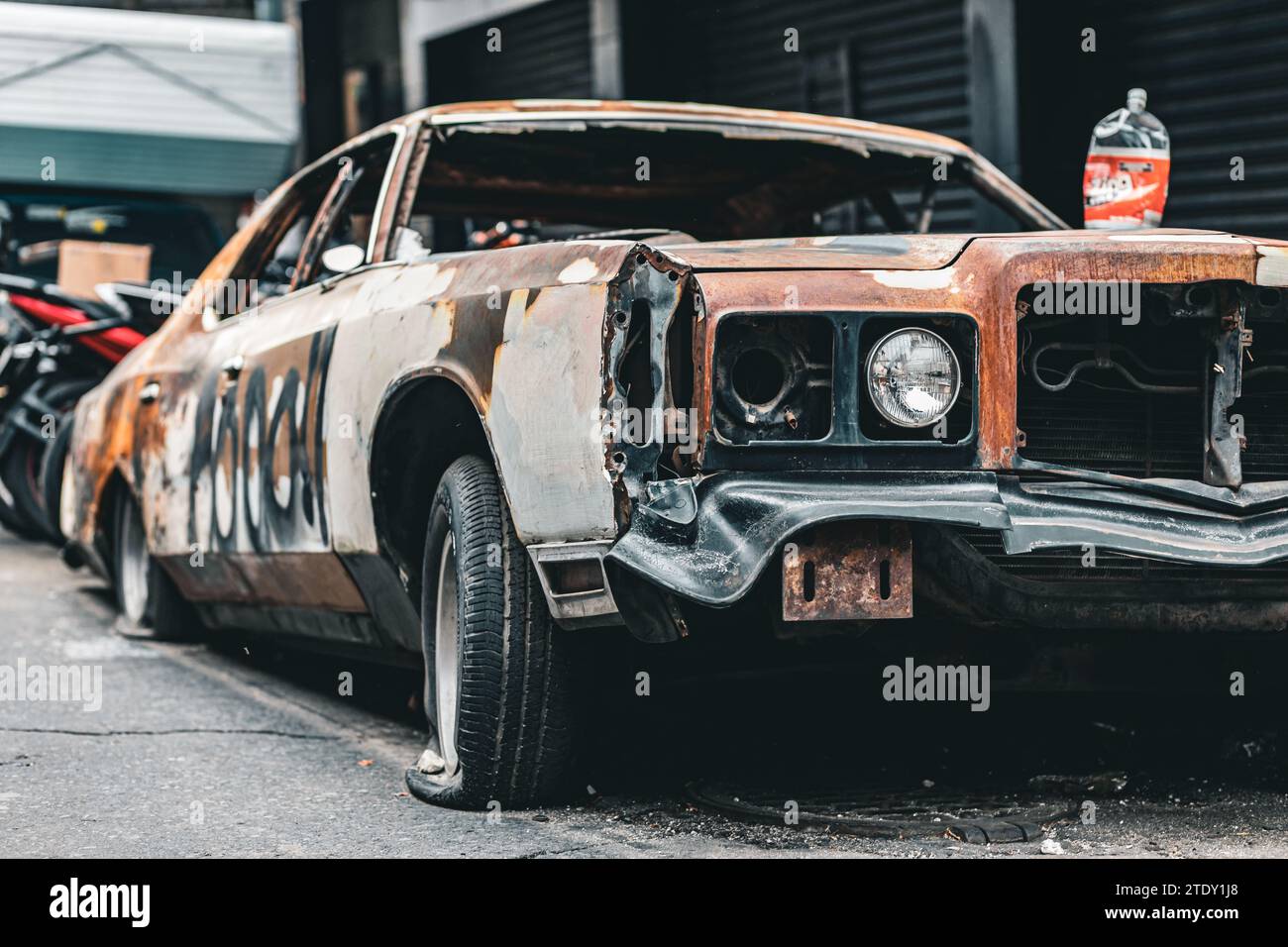 classic american car wreck, burned, rusty, historical city center ...