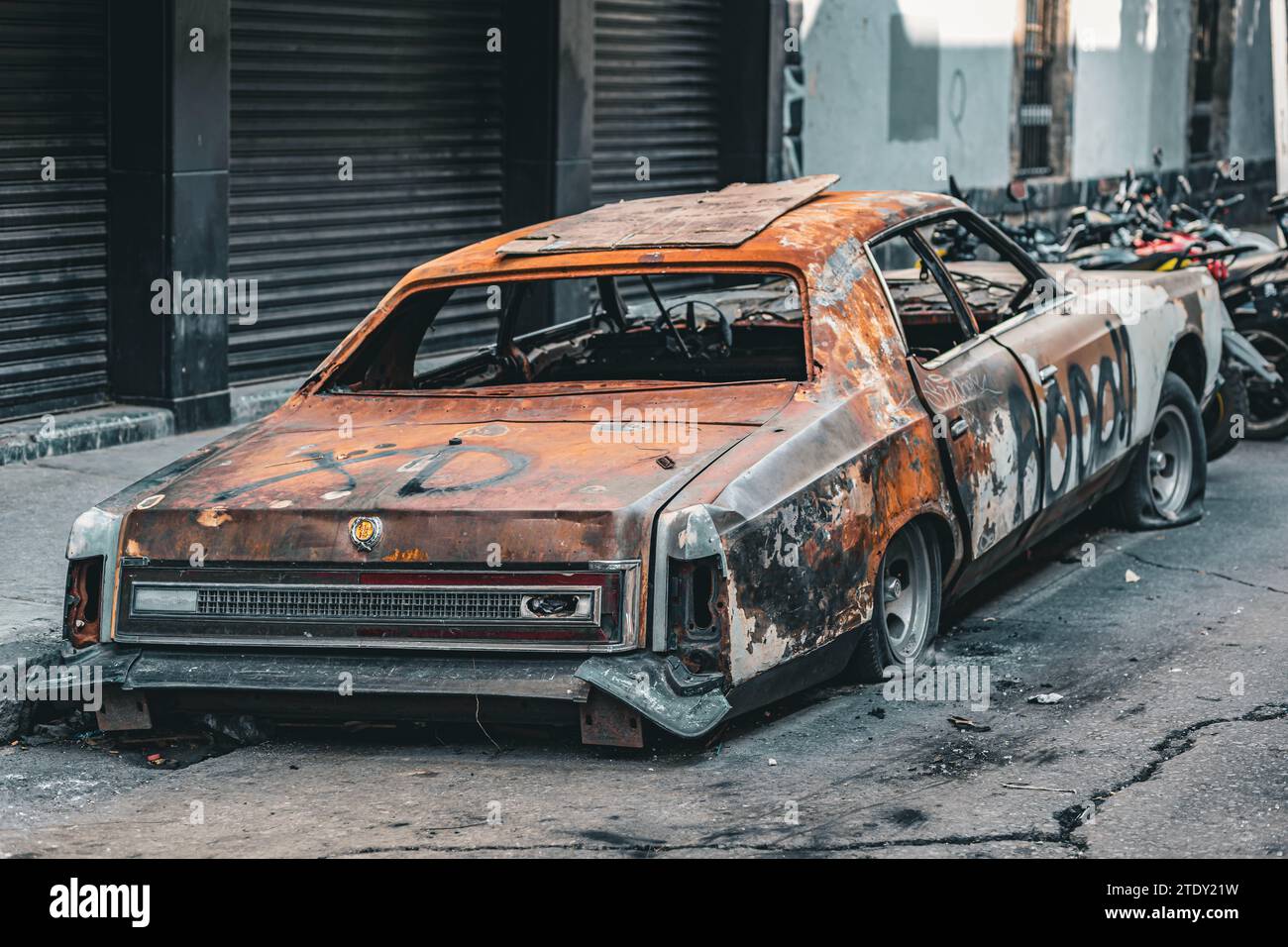 classic american car wreck, burned, rusty, historical city center ...