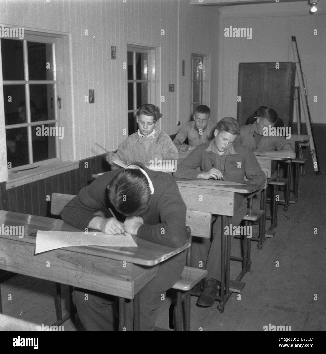 Children in classroom at school desks studying and working ca. October ...