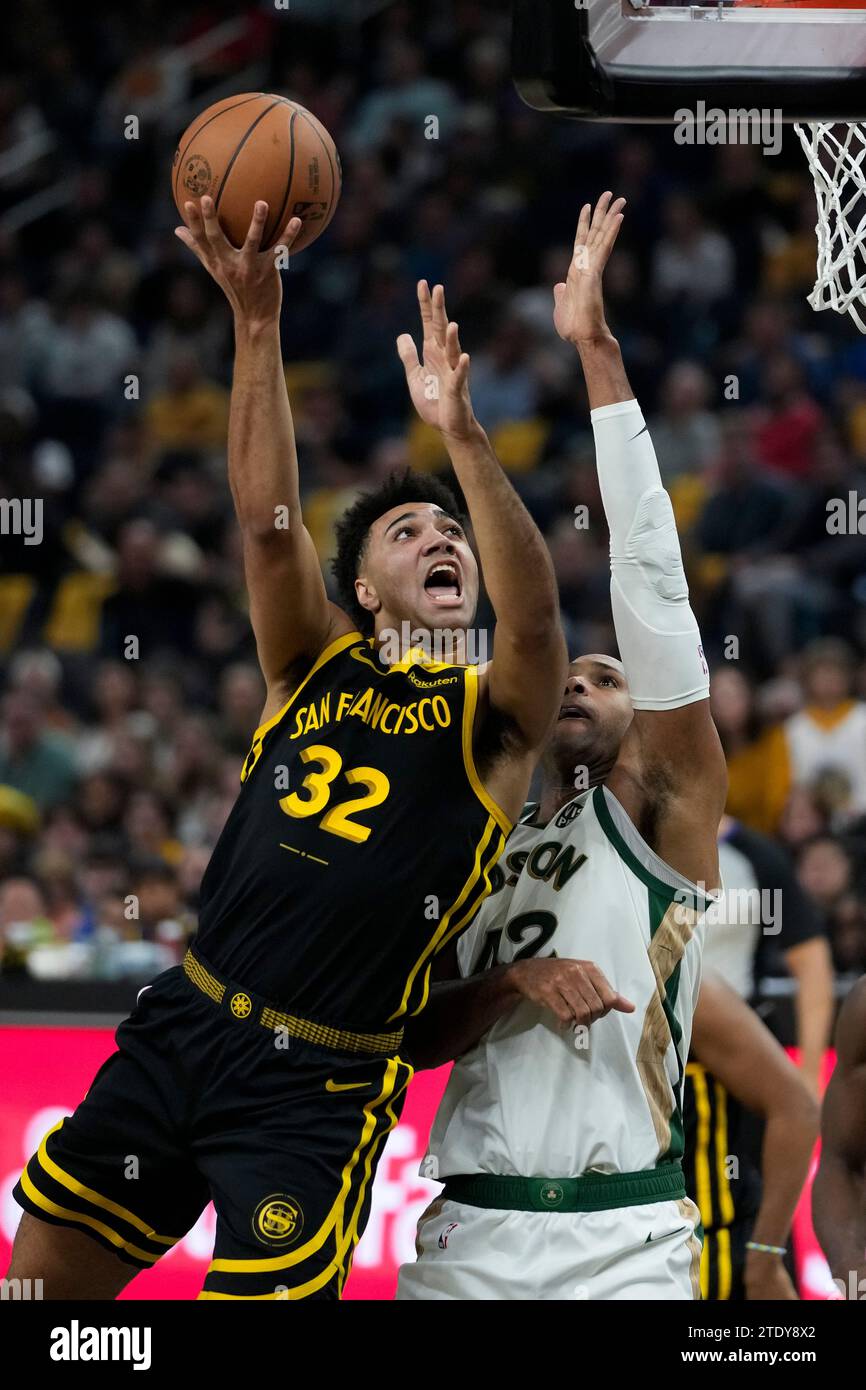 Golden State Warriors forward Trayce Jackson-Davis, left, shoots while ...