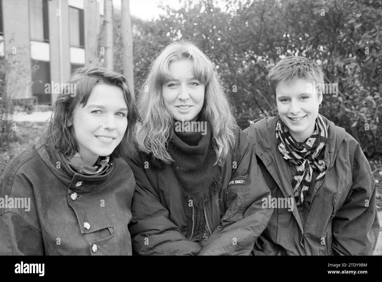 Three Swedish girls at H.D., posing in front of a company building ...
