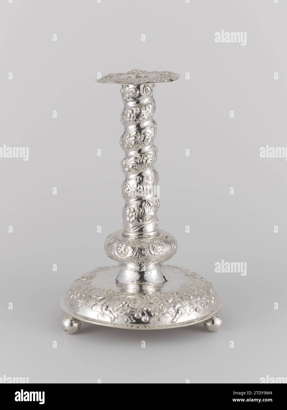 Candlestick with a twisted trunk, decorated with flowers and putti ...