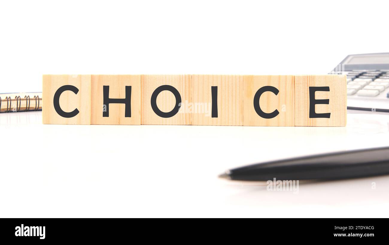 CHOICE WORD word assembled from wooden cubes next to a calculator, pen ...