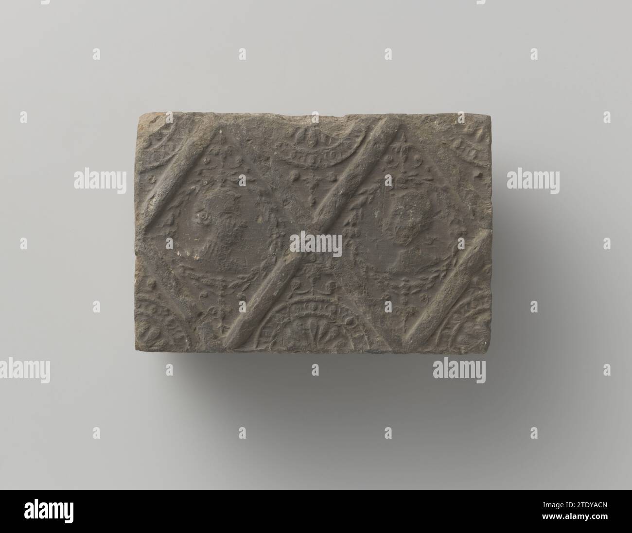 Hearing stone with a representation of a men's and women's head in two ...