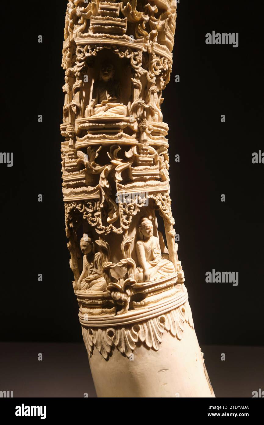 A detail in a display of an intricately carved ivory elephant tusk ...